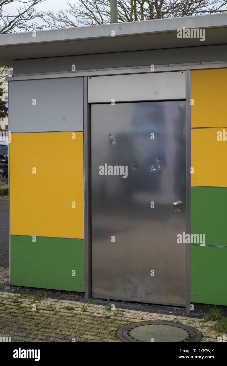 Shiny metallic sliding door of a colorful prefabricated public toilet ...