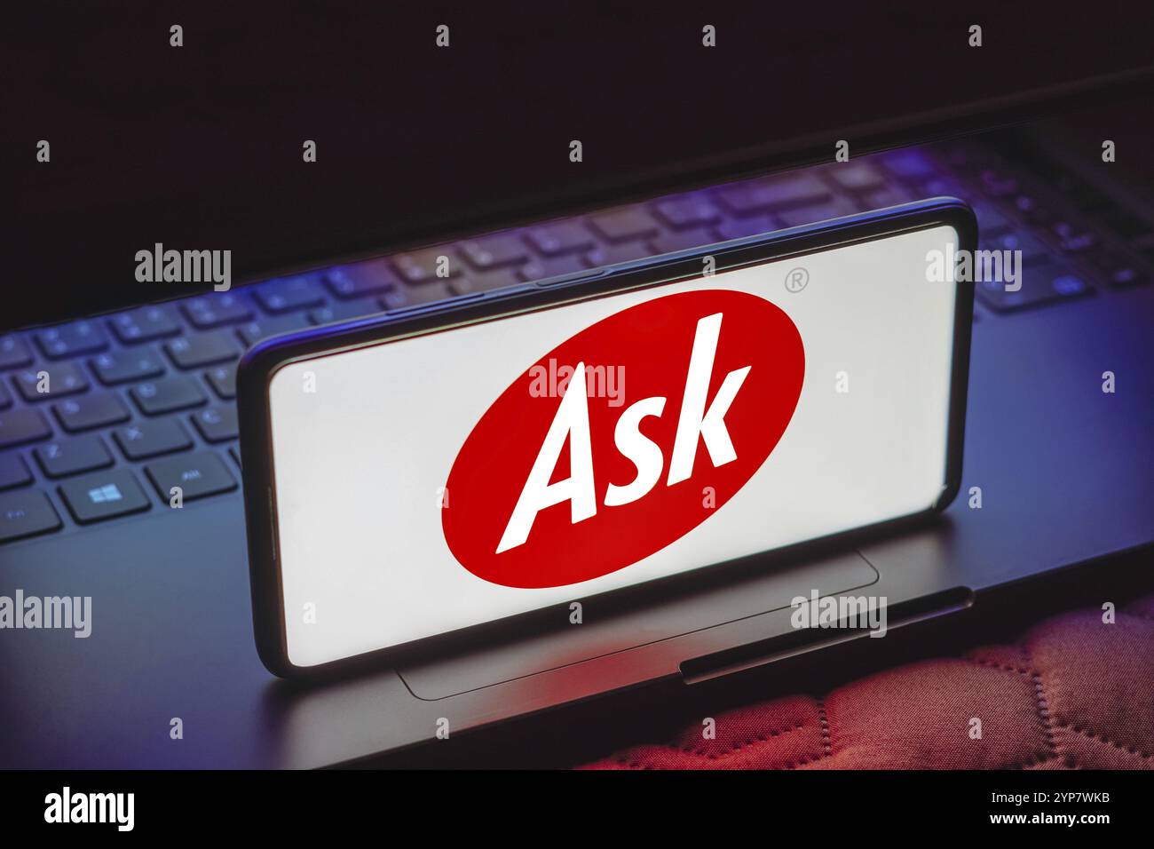 In this photo illustration, the Ask logo is displayed on a smartphone screen Stock Photo - Alamy