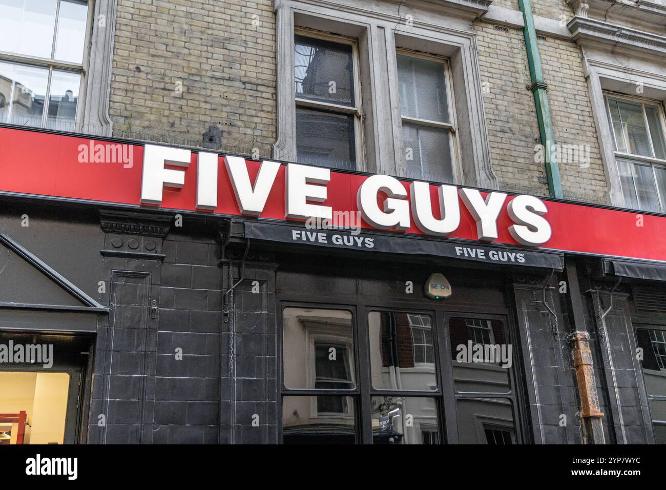London, UK- September 19, 2024: Five Guys restaurant exterior, red sign ...