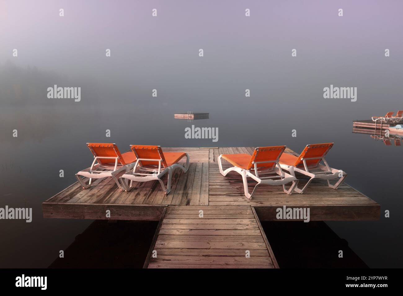 View of a boat dock the Lac-Superieur, misty morning with fog, in ...