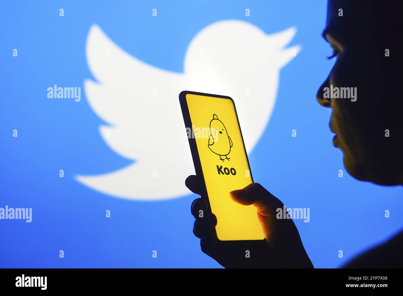 In this photo illustration, a woman's silhouette holds a smartphone ...