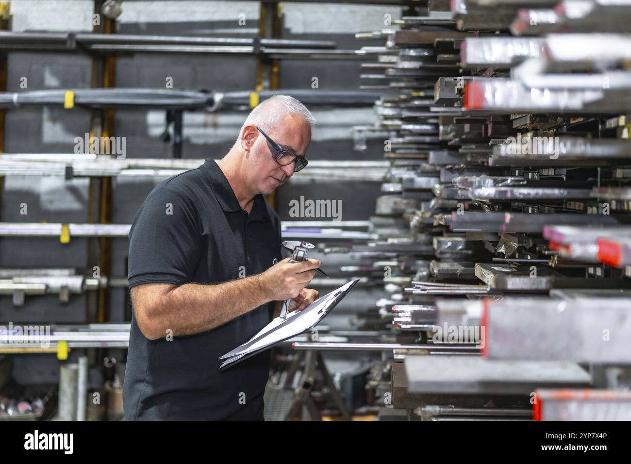 Mature caucasian man inspecting quality control of metal bars doing ...