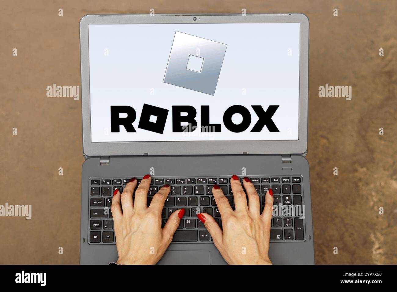 In this photo illustration, the Roblox logo is displayed on a laptop ...