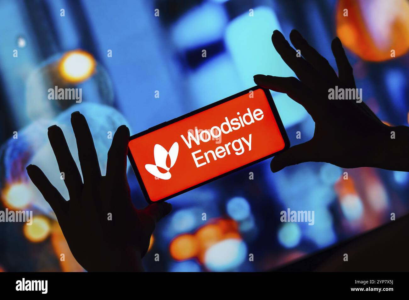 In this photo illustration, the Woodside Energy logo is seen displayed ...