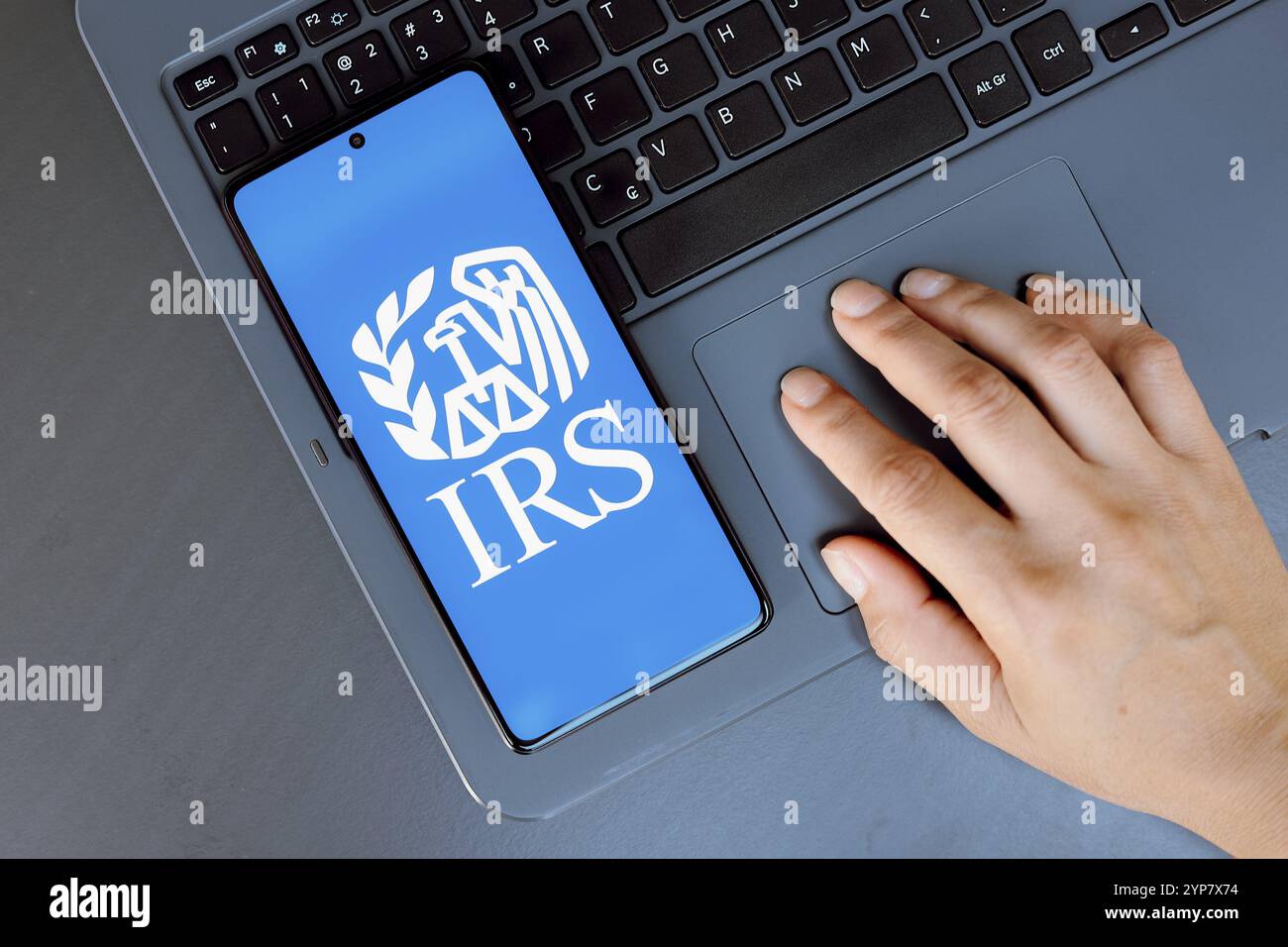 In this photo illustration, the Internal Revenue Service (IRS) logo is ...