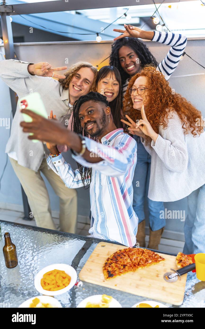Vertical photo of a smiling african man taking selfie with multi-ethic ...