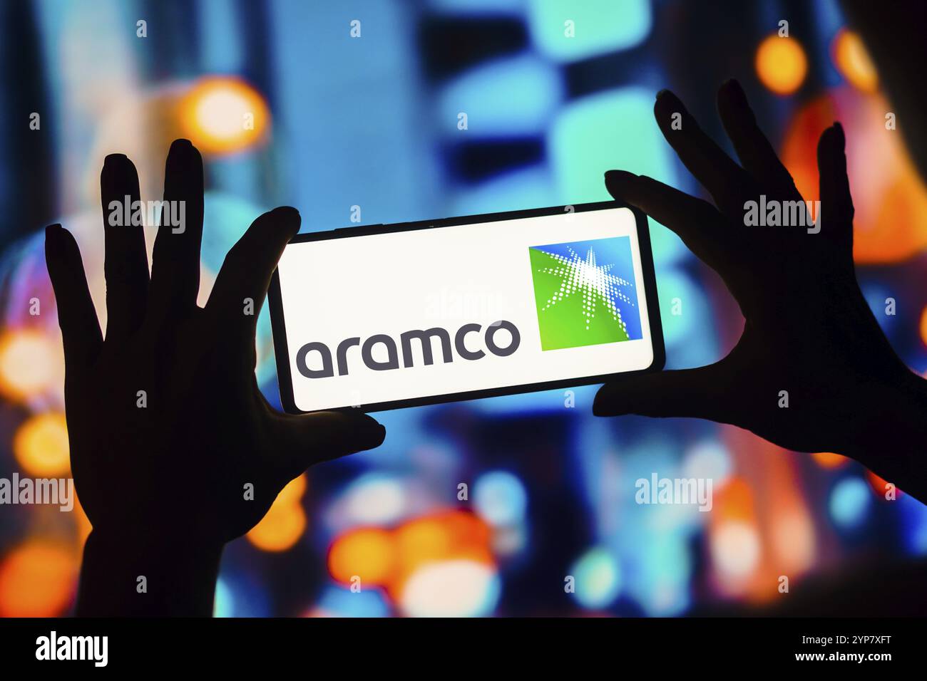 In this photo illustration, the Aramco logo is displayed on a ...