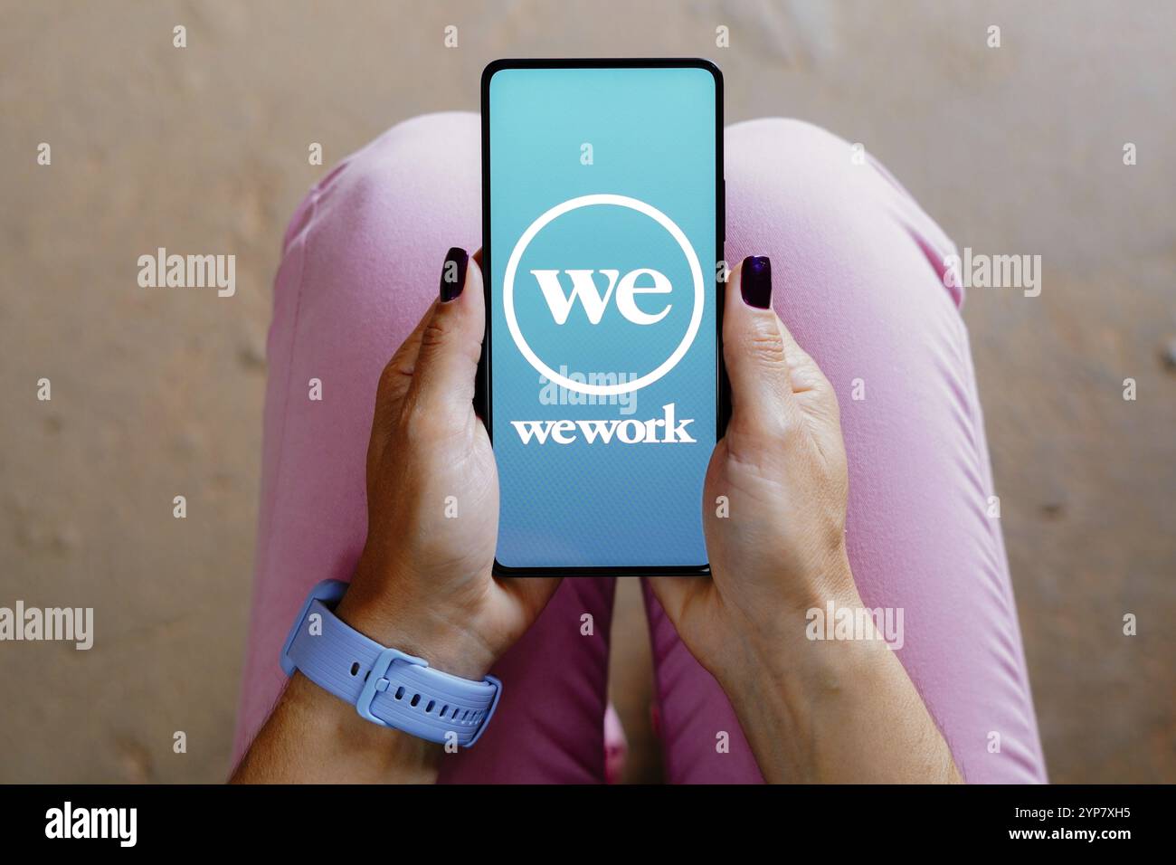 In this photo illustration, the WeWork logo is displayed on a ...