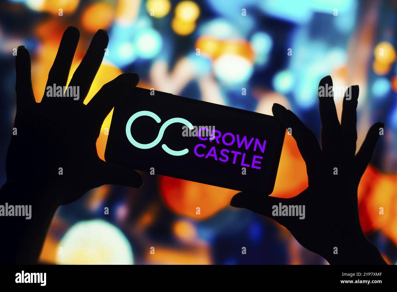 In this photo illustration, the Crown Castle logo is displayed on a ...