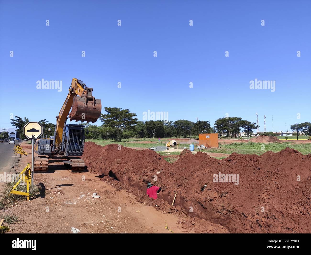 A backhoe working on the maintenance work of a sewage gallery in ...