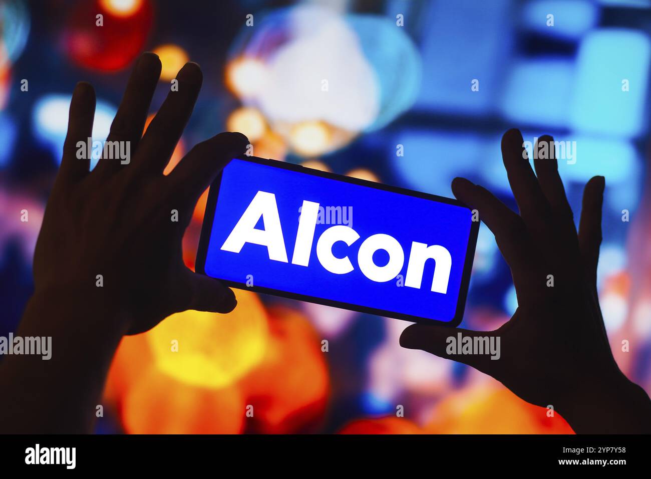 In this photo illustration, the Alcon logo is displayed on a smartphone ...
