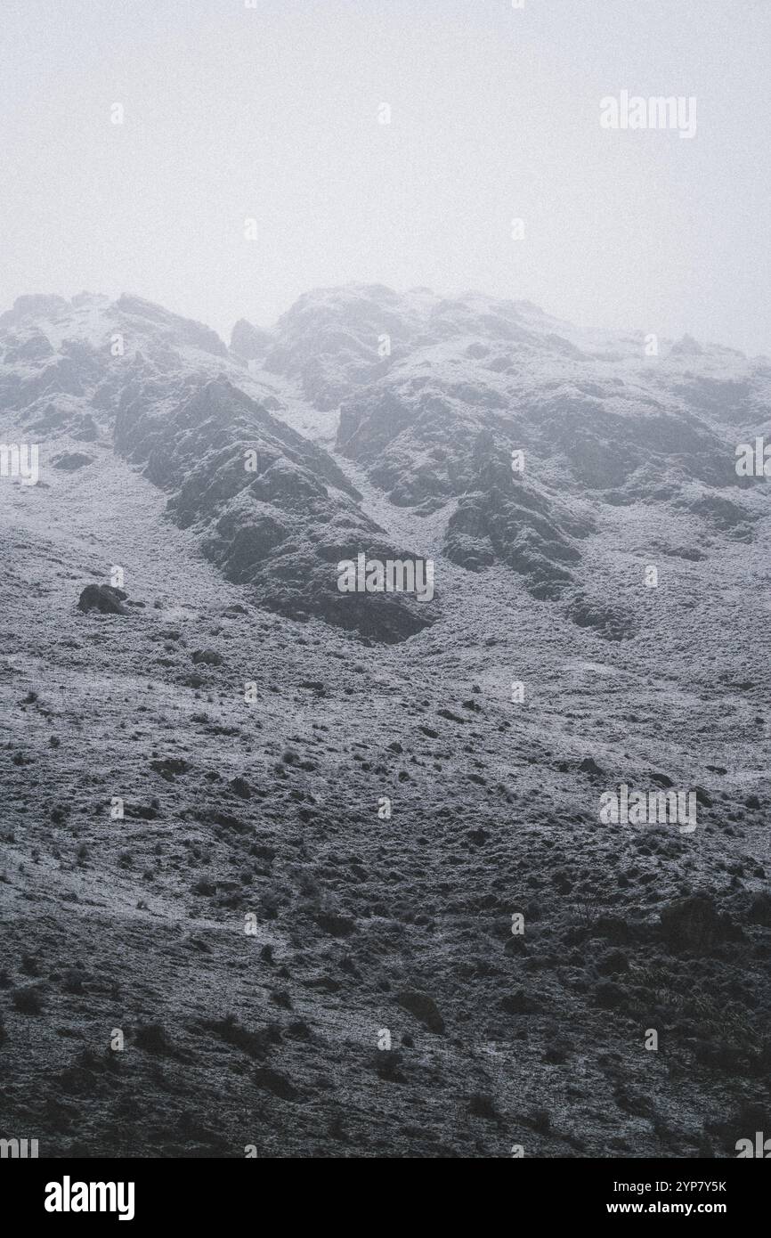 Snow-covered mountains with grey, rough surface in lonely surroundings ...