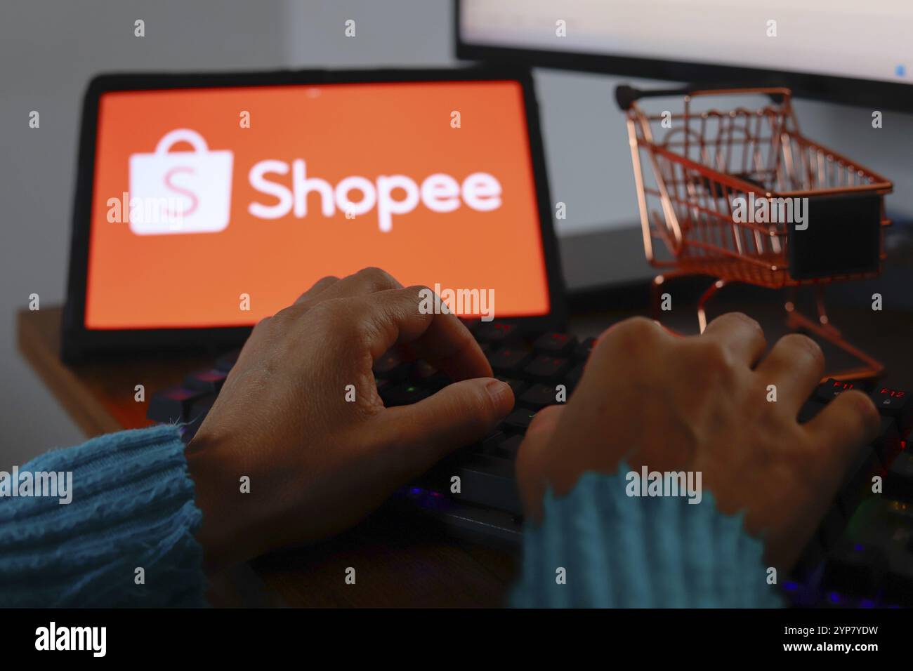 In this photo illustration, a person typing and in the background the ...