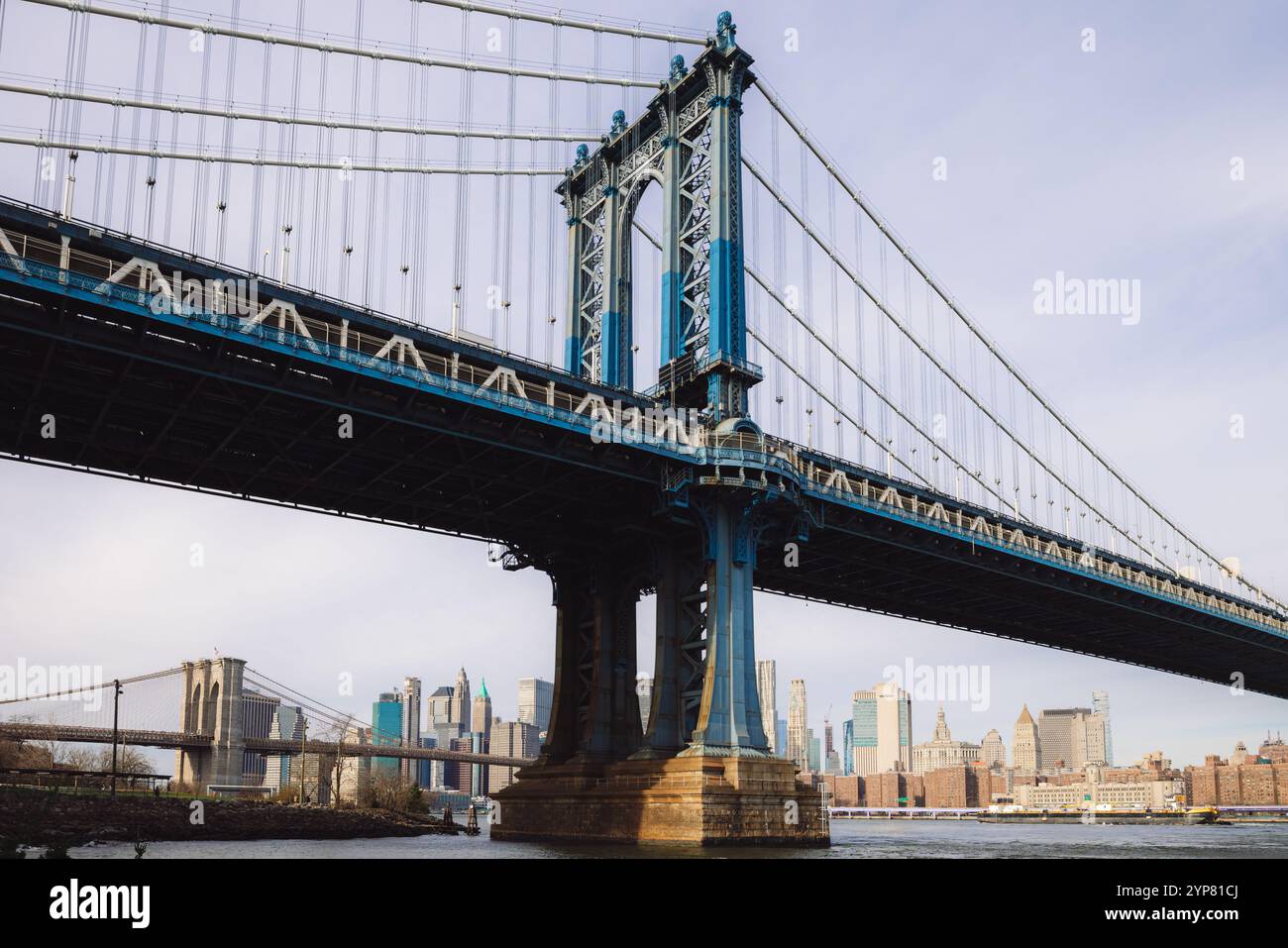 A dramatic view of the Manhattan Bridge with its intricate steel design ...