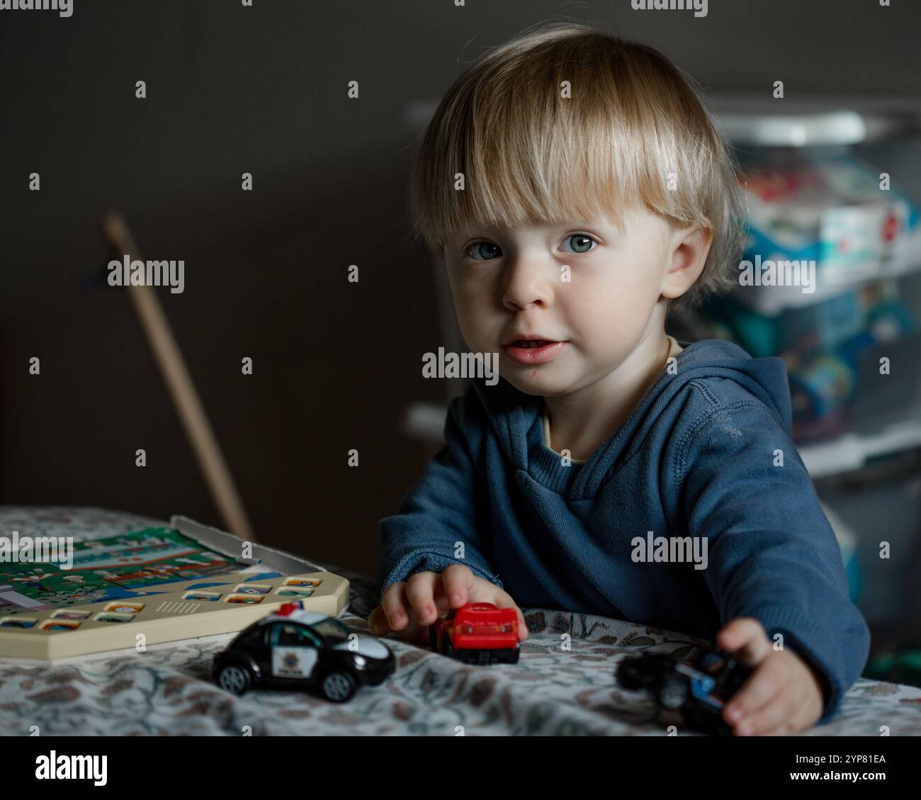 Toddler kid boy playing at the troom with many toys, cars Stock Photo ...