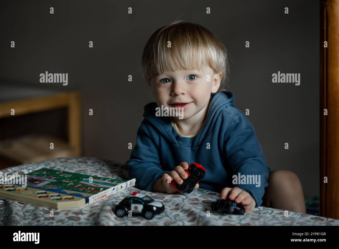 Toddler kid boy playing at the troom with many toys, cars Stock Photo ...