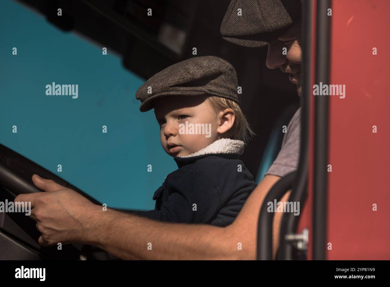 A Cute little boy driving is fathers truck with Dad Stock Photo - Alamy