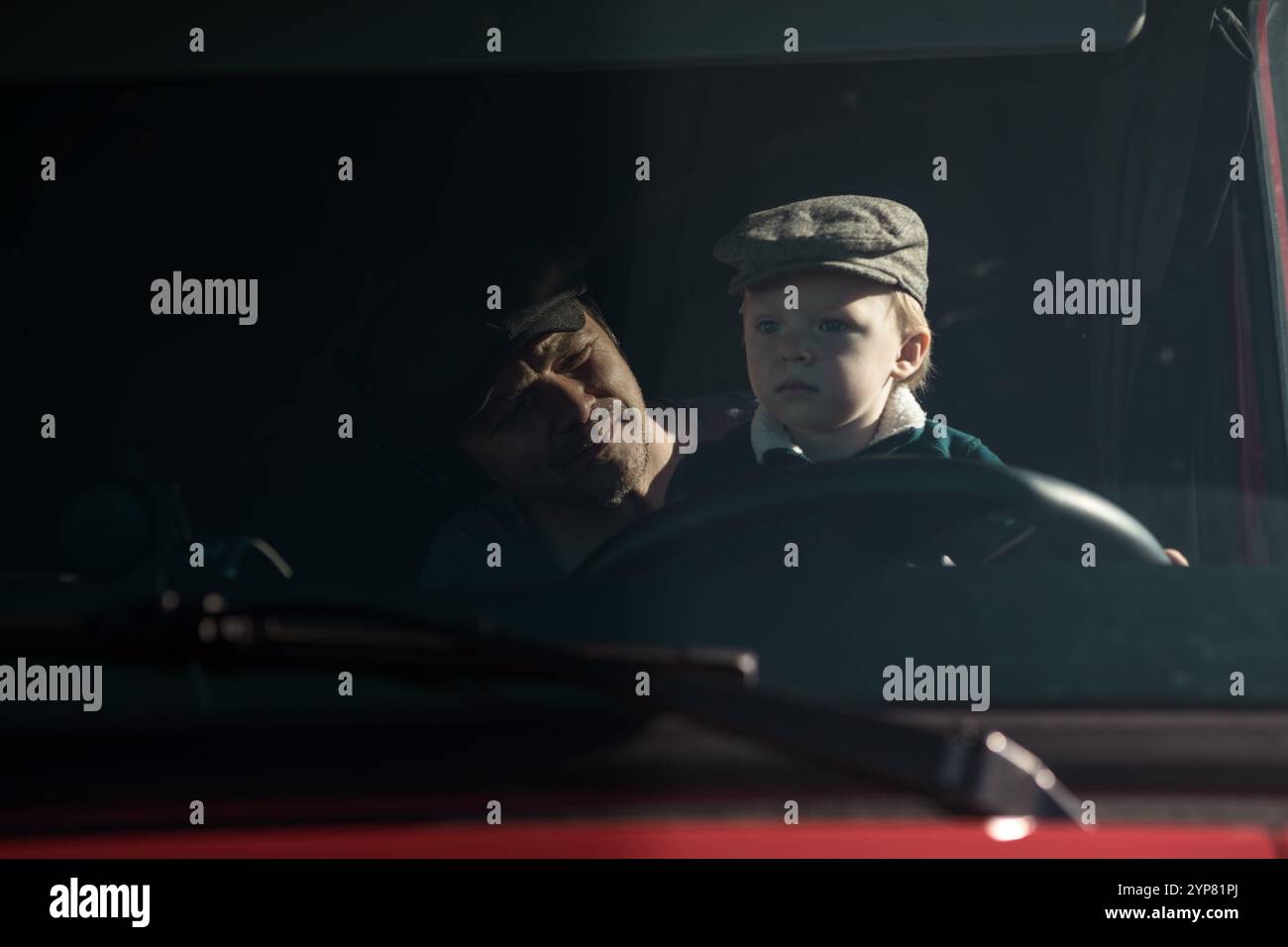A Cute little boy driving is fathers truck with Dad Stock Photo - Alamy