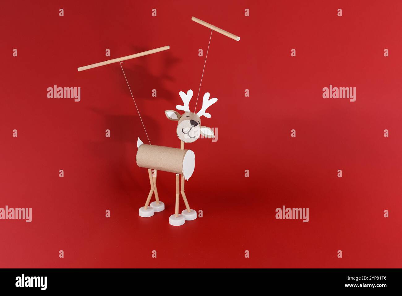 a handmade reindeer craft made from various materials, cardboard tube ...