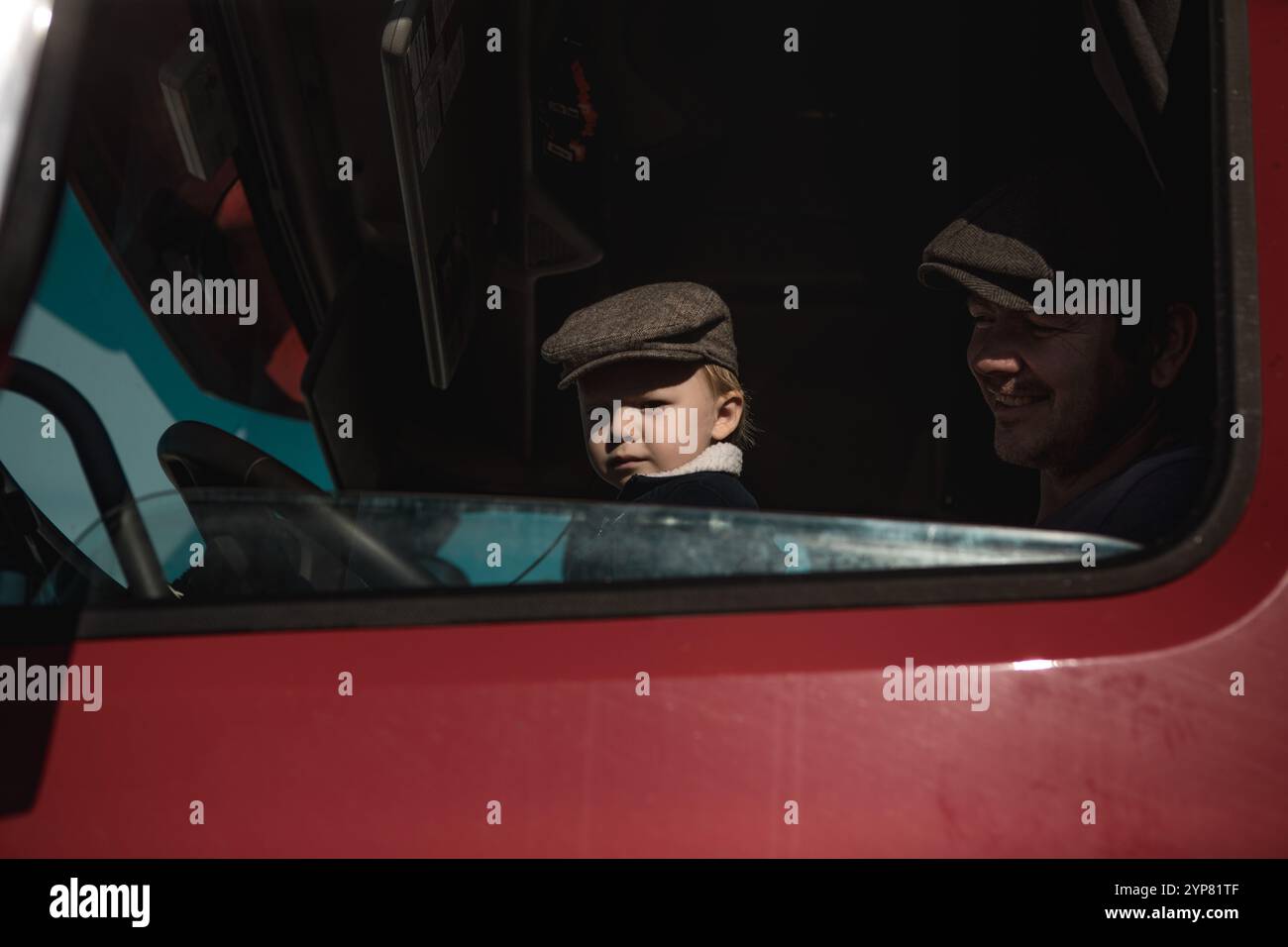 A Cute little boy driving is fathers truck with Dad Stock Photo - Alamy