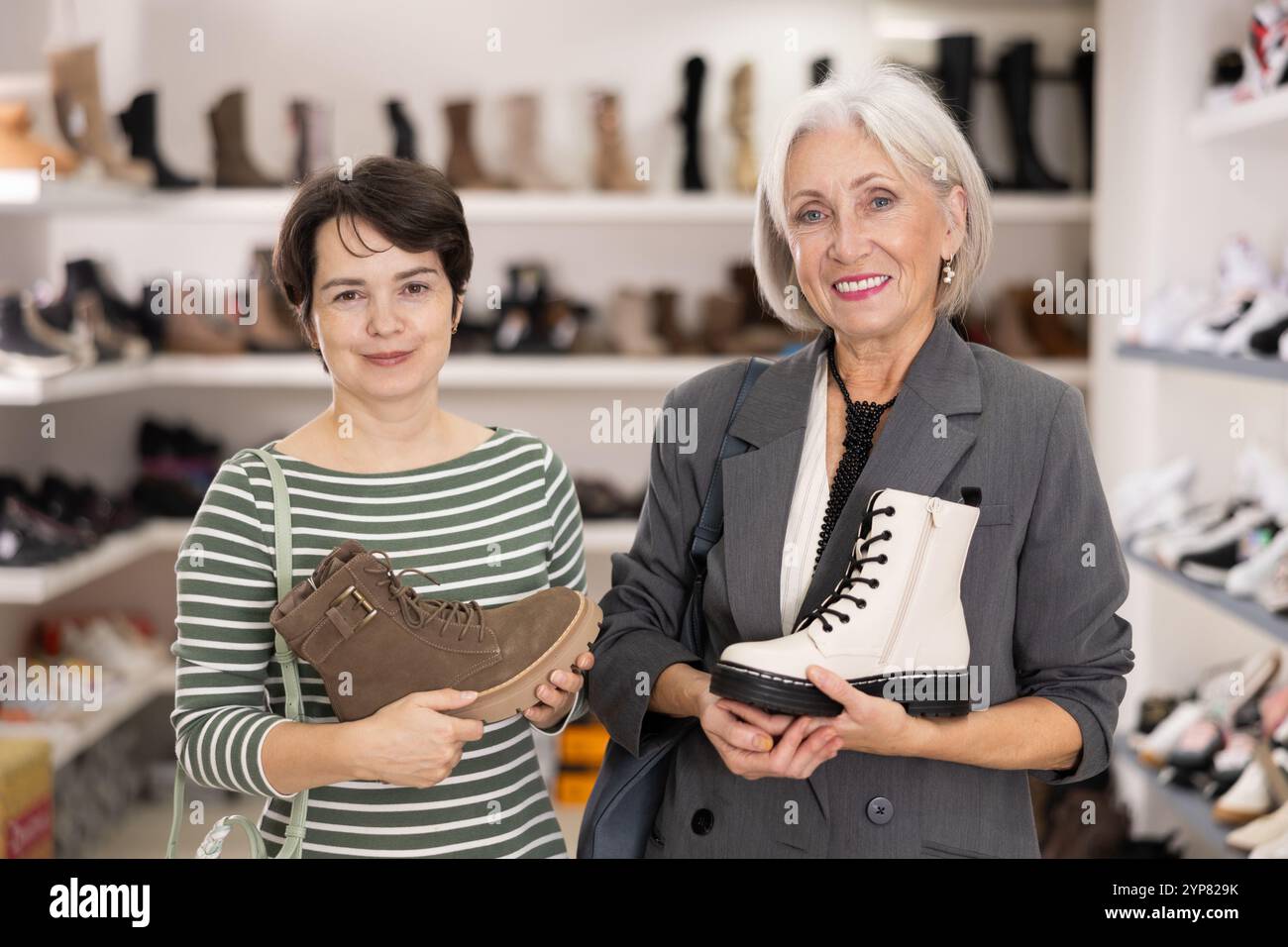 Two women are shopping in shoe store Stock Photo - Alamy