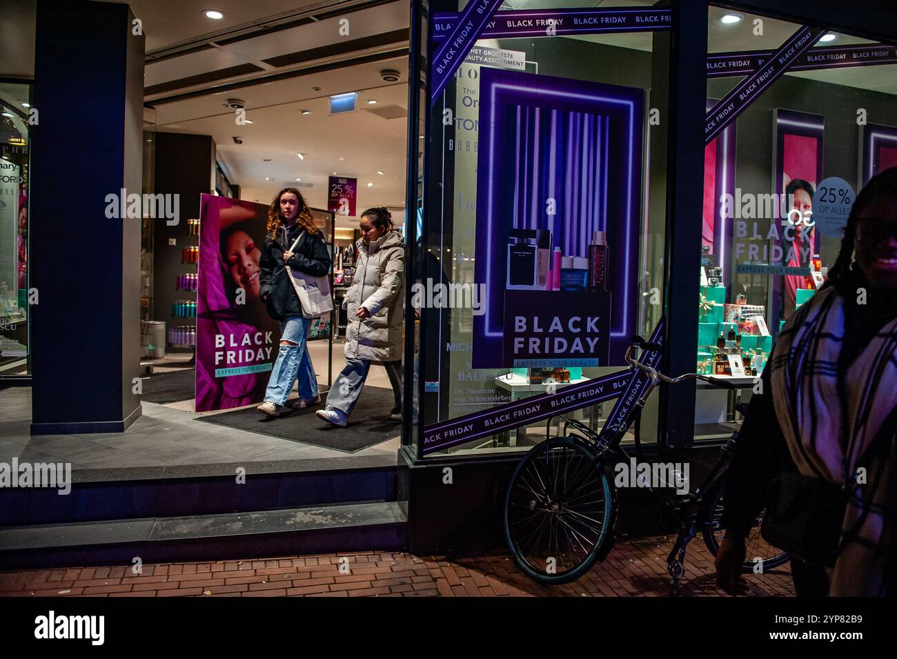 Two women coming out store hi-res stock photography and images - Alamy
