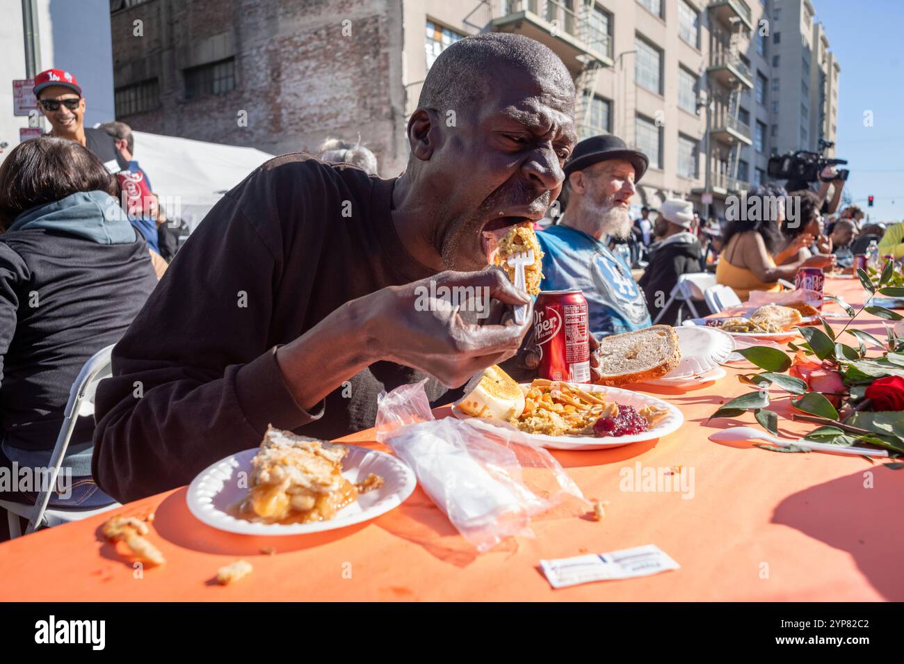 People enjoy their Thanksgiving meal. Thousands of Skid Row residents ...