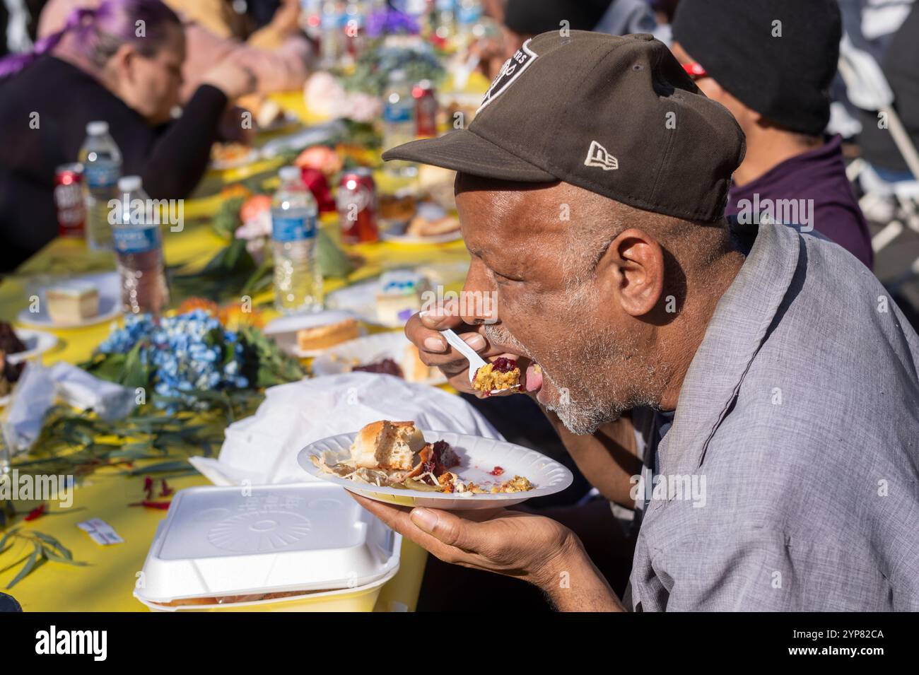 People enjoy their Thanksgiving meal. Thousands of Skid Row residents ...