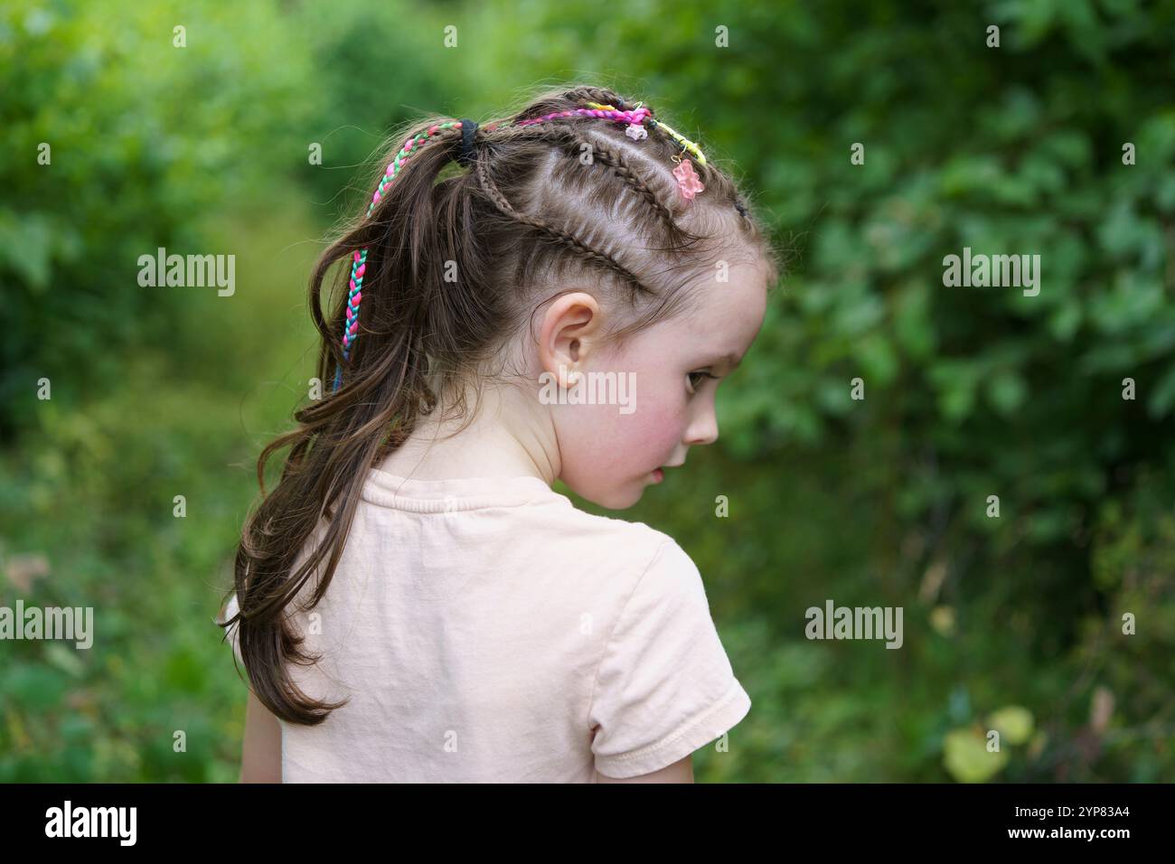 Little sad girl with dreadlocks and missing front tooth walks in the ...