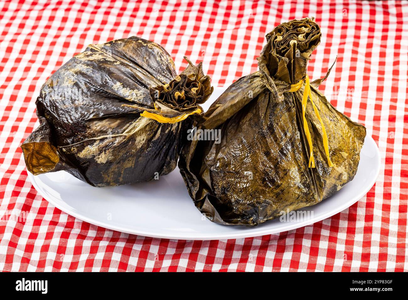 Traditional Colombian tamales - Wrapped in green banana leaves Stock ...