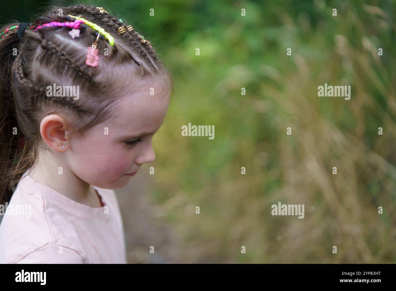Little sad girl with dreadlocks and missing front tooth walks in the ...