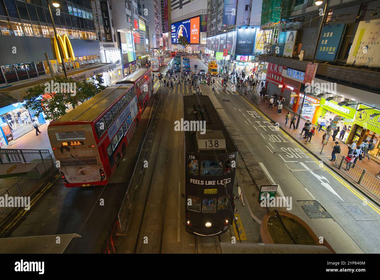 Bustling shopping area in Causeway bay at night with busses and trams along Hennessy Road. Hong ...