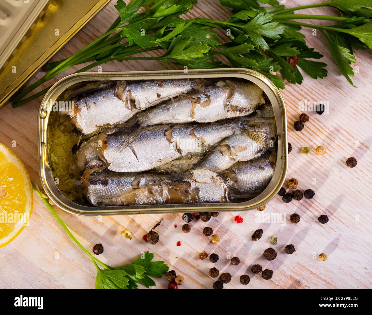 Pilchards in oil with greens and lemon Stock Photo - Alamy