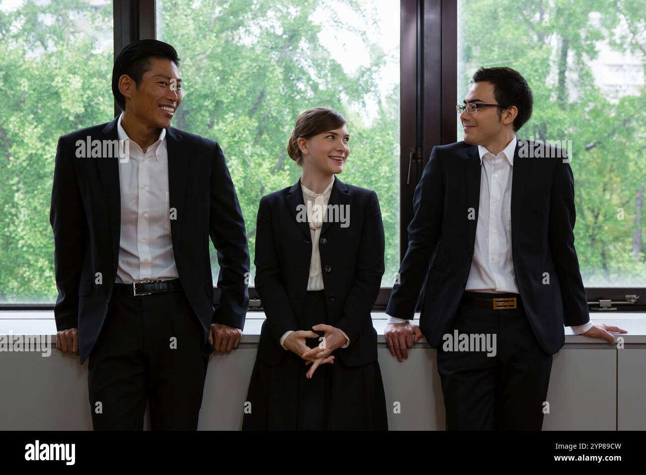 Business people talking by the window Stock Photo - Alamy