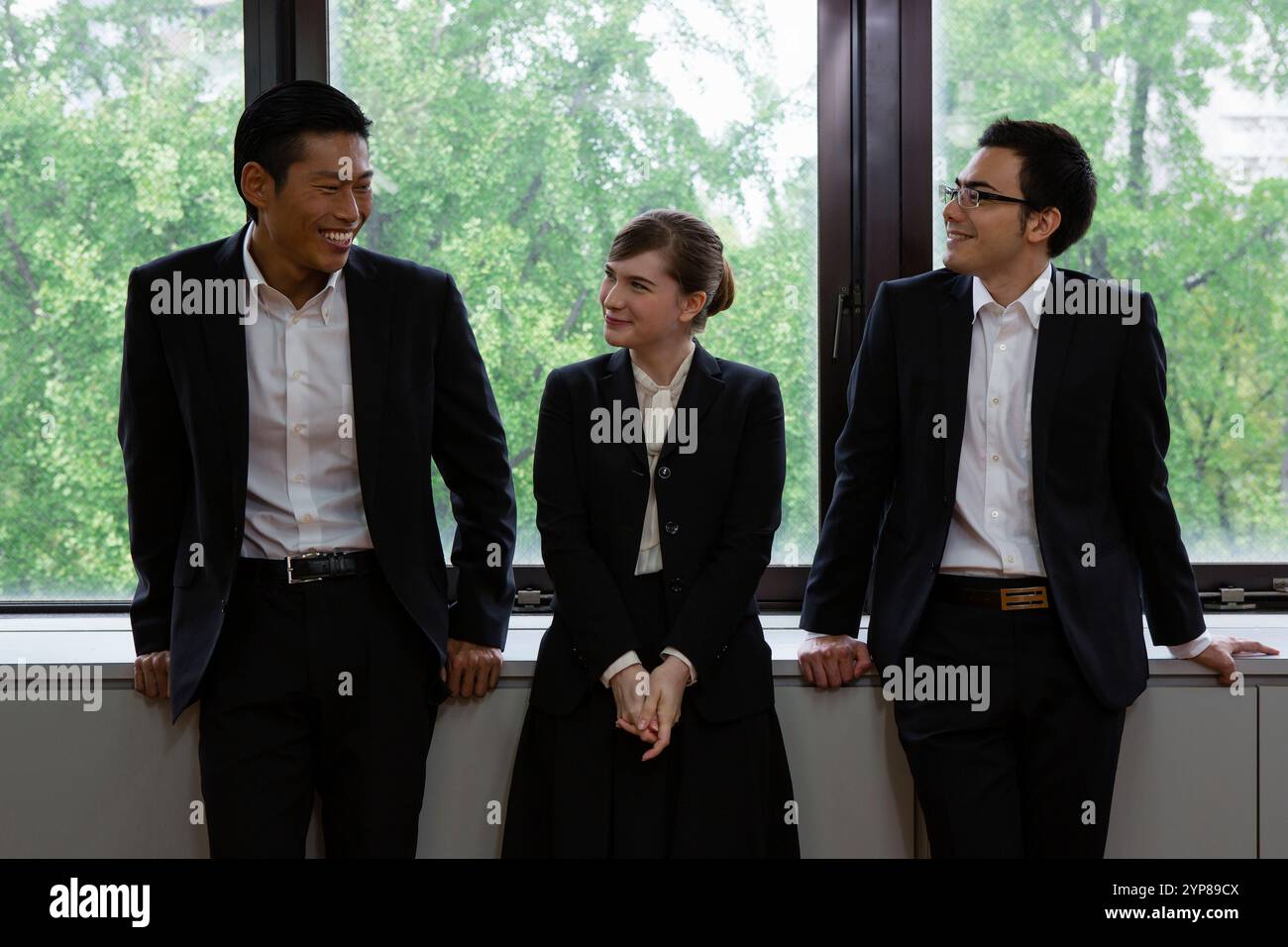 Business people talking by the window Stock Photo - Alamy