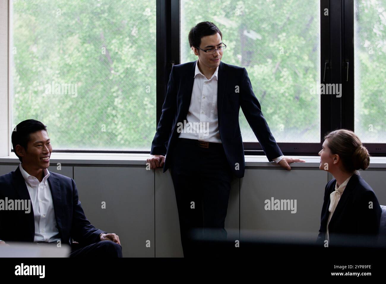 Business people talking by the window Stock Photo - Alamy