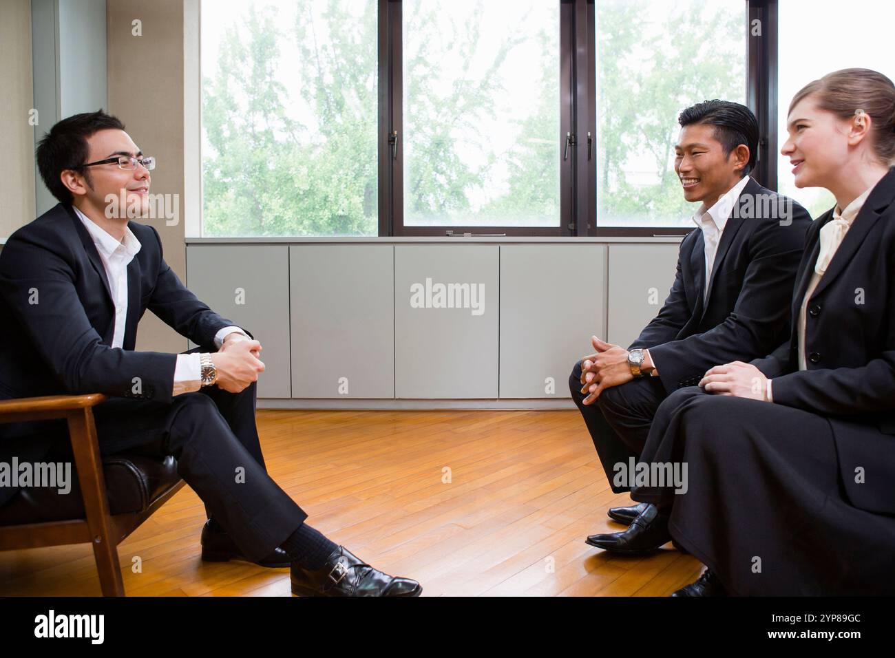 Business people sitting opposite each other Stock Photo - Alamy