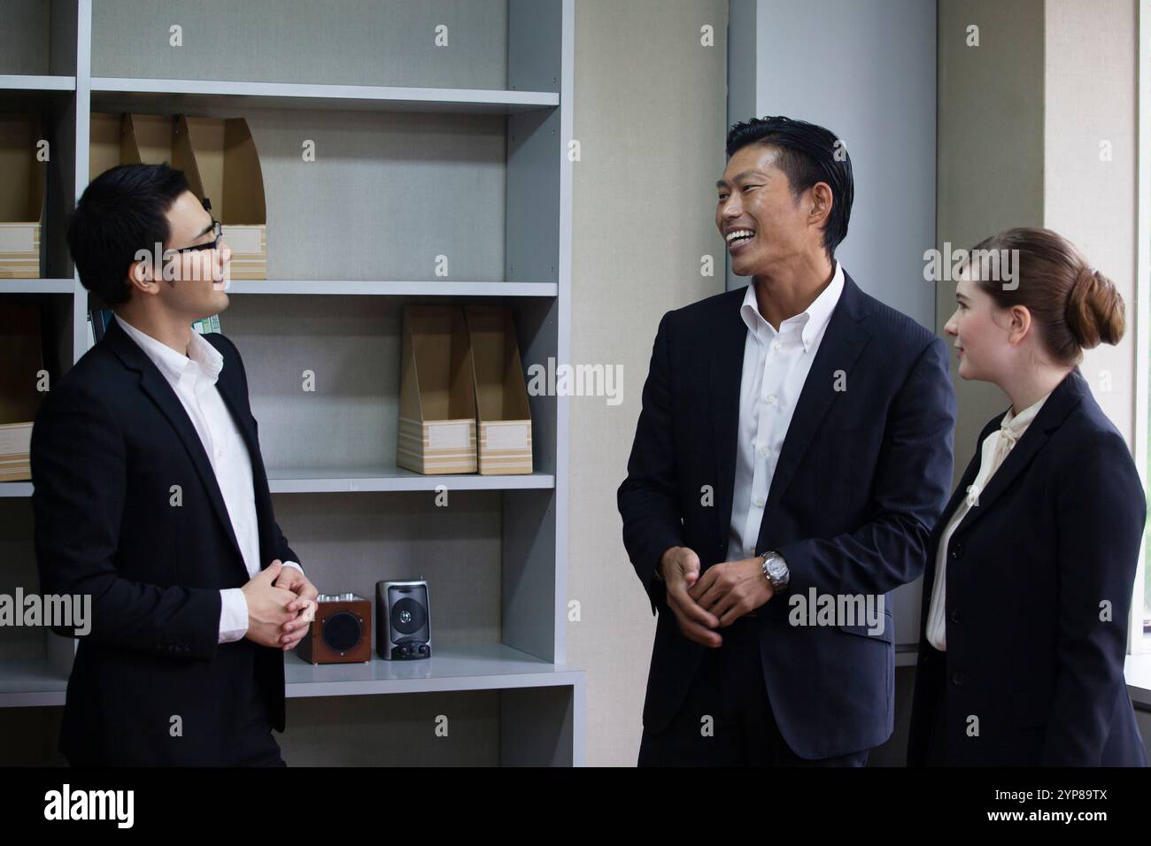 Business people talking around a desk Stock Photo - Alamy