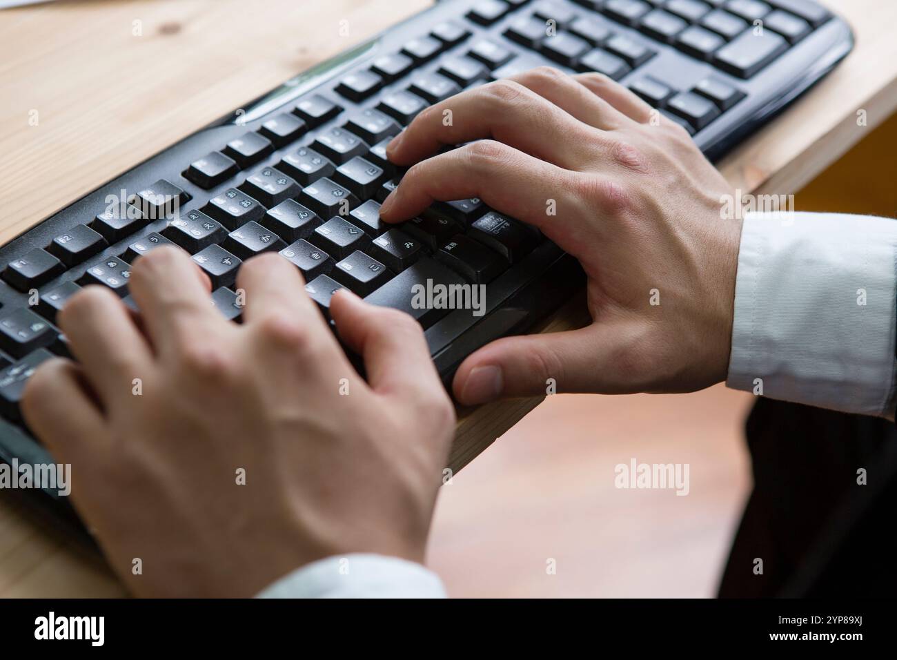 Hand typing on keyboard Stock Photo - Alamy