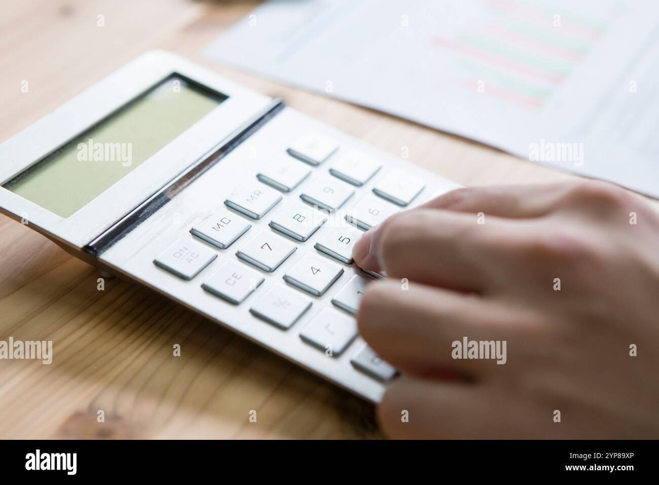Hand tapping on calculator hi-res stock photography and images - Alamy