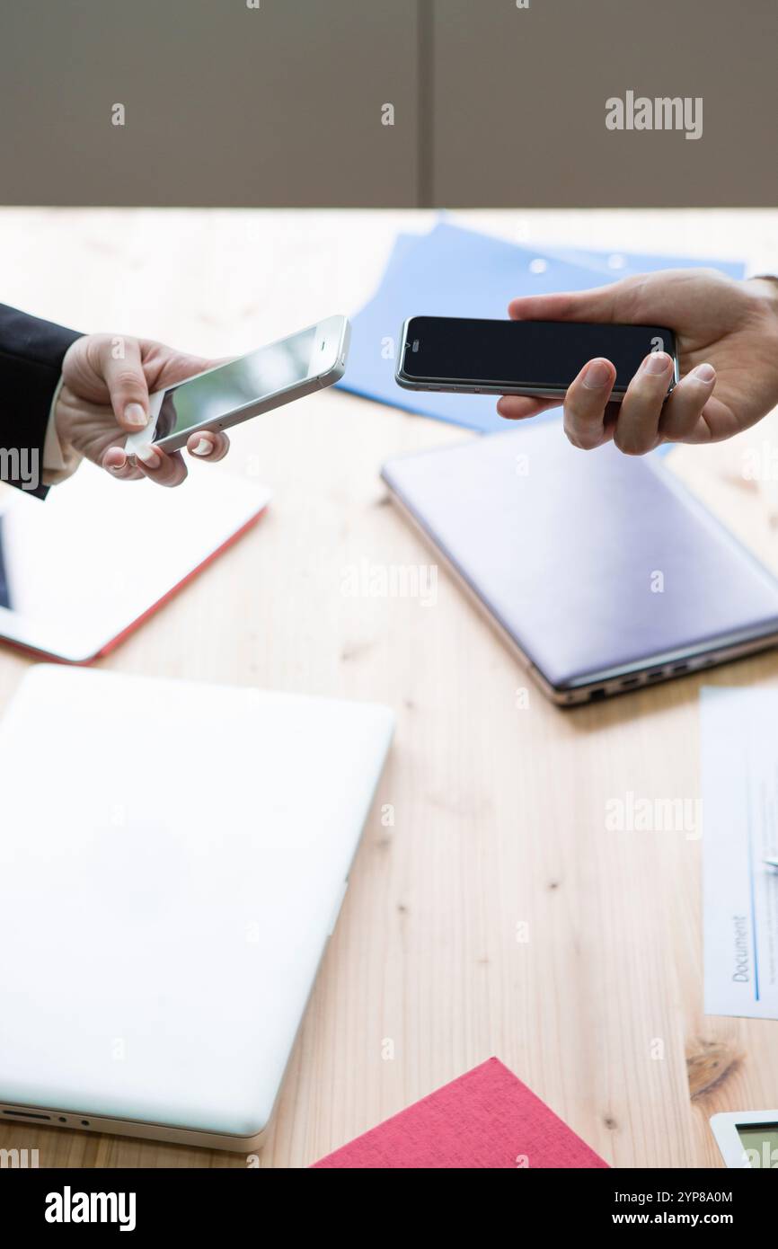 Business people exchanging contact details Stock Photo - Alamy