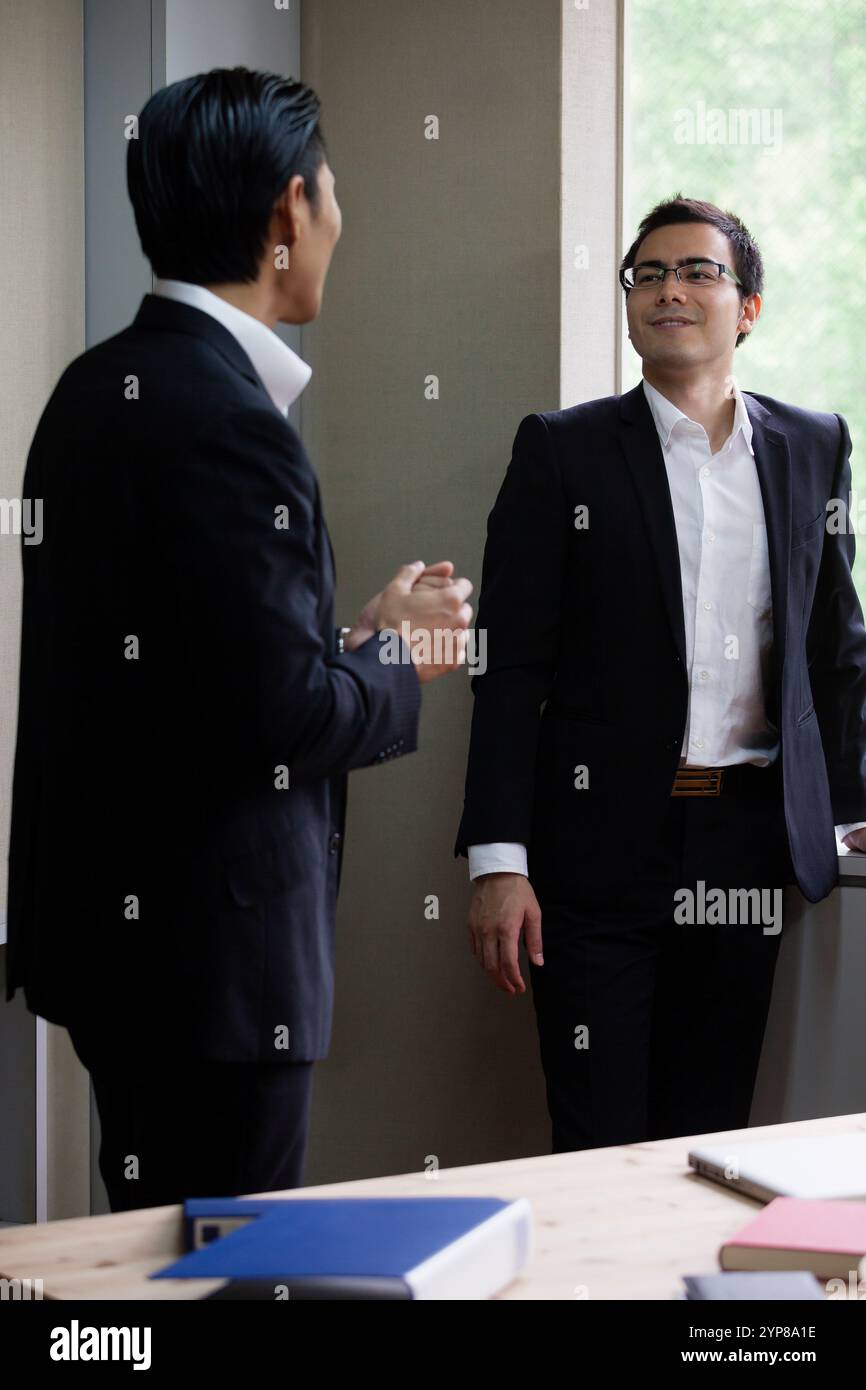 Business people talking by the window Stock Photo - Alamy