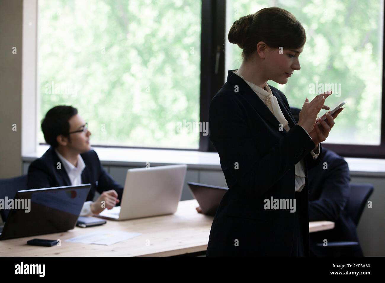 Businesswoman fiddling with her phone Stock Photo - Alamy