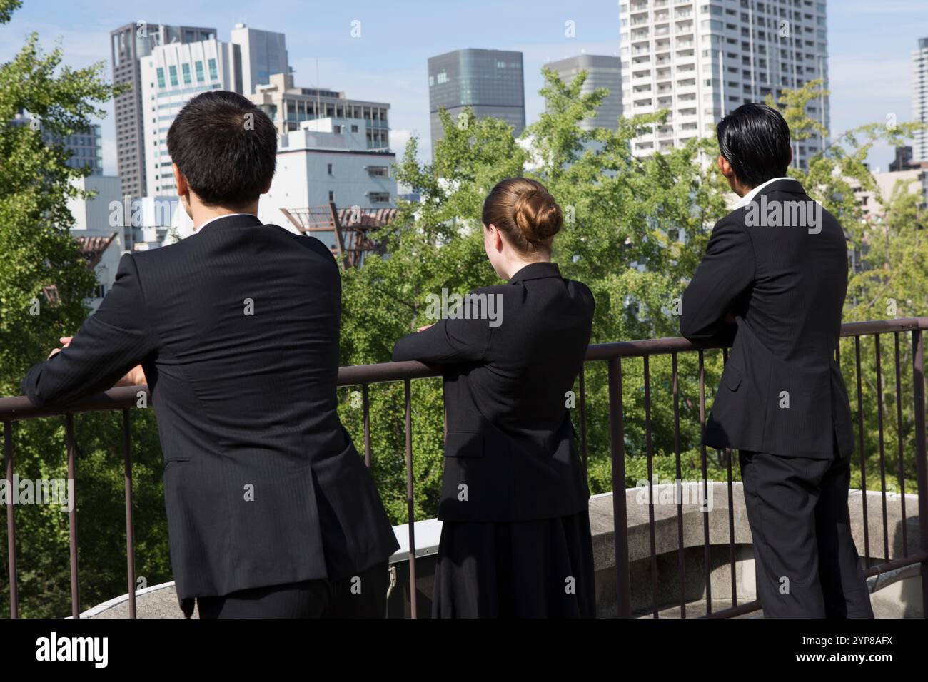 Business people looking out from the rooftop at the office area Stock ...