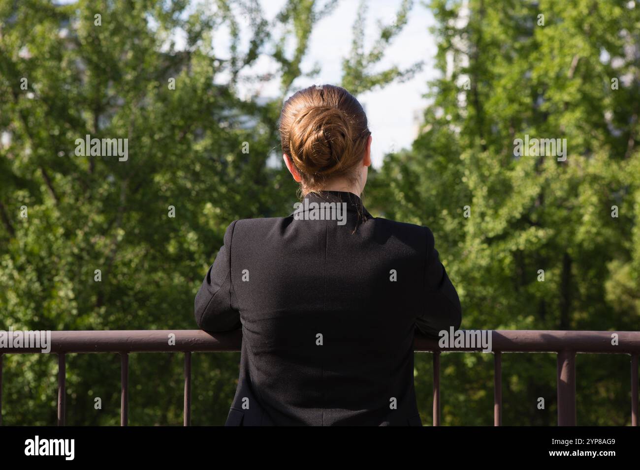 Business people looking out from rooftop Stock Photo - Alamy