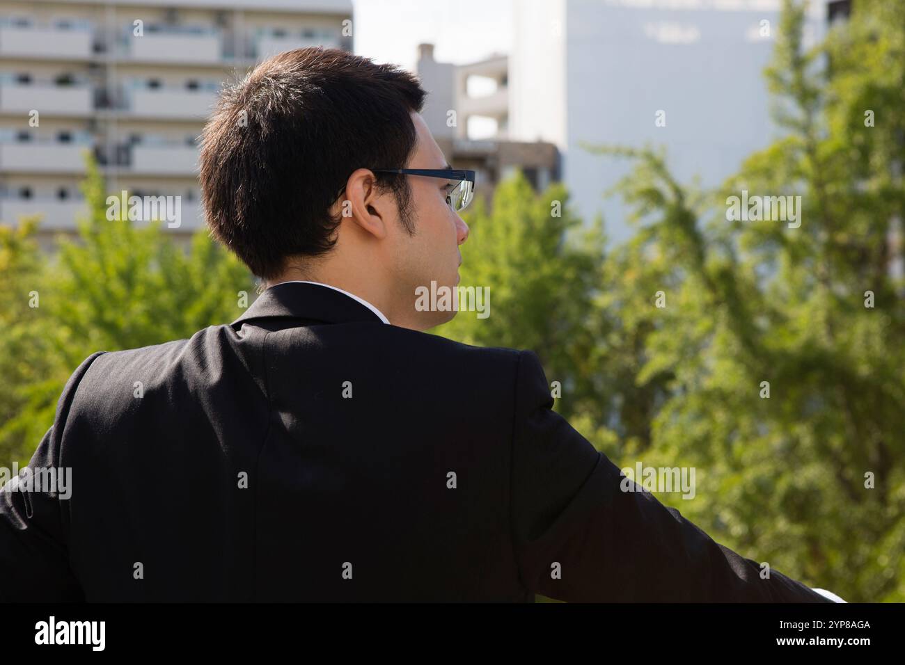 Business people looking out from rooftop Stock Photo - Alamy
