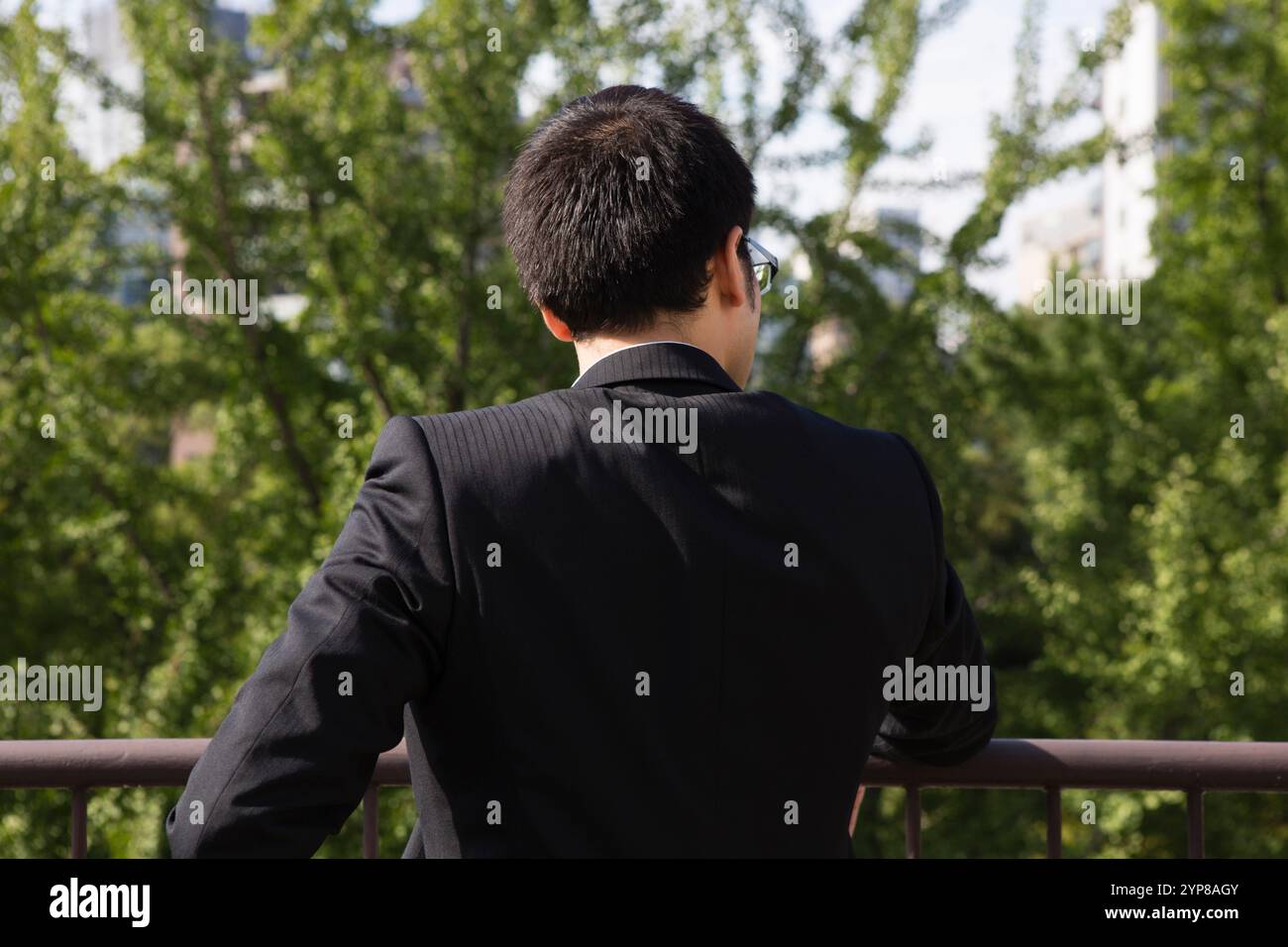 Business people looking out from rooftop Stock Photo - Alamy
