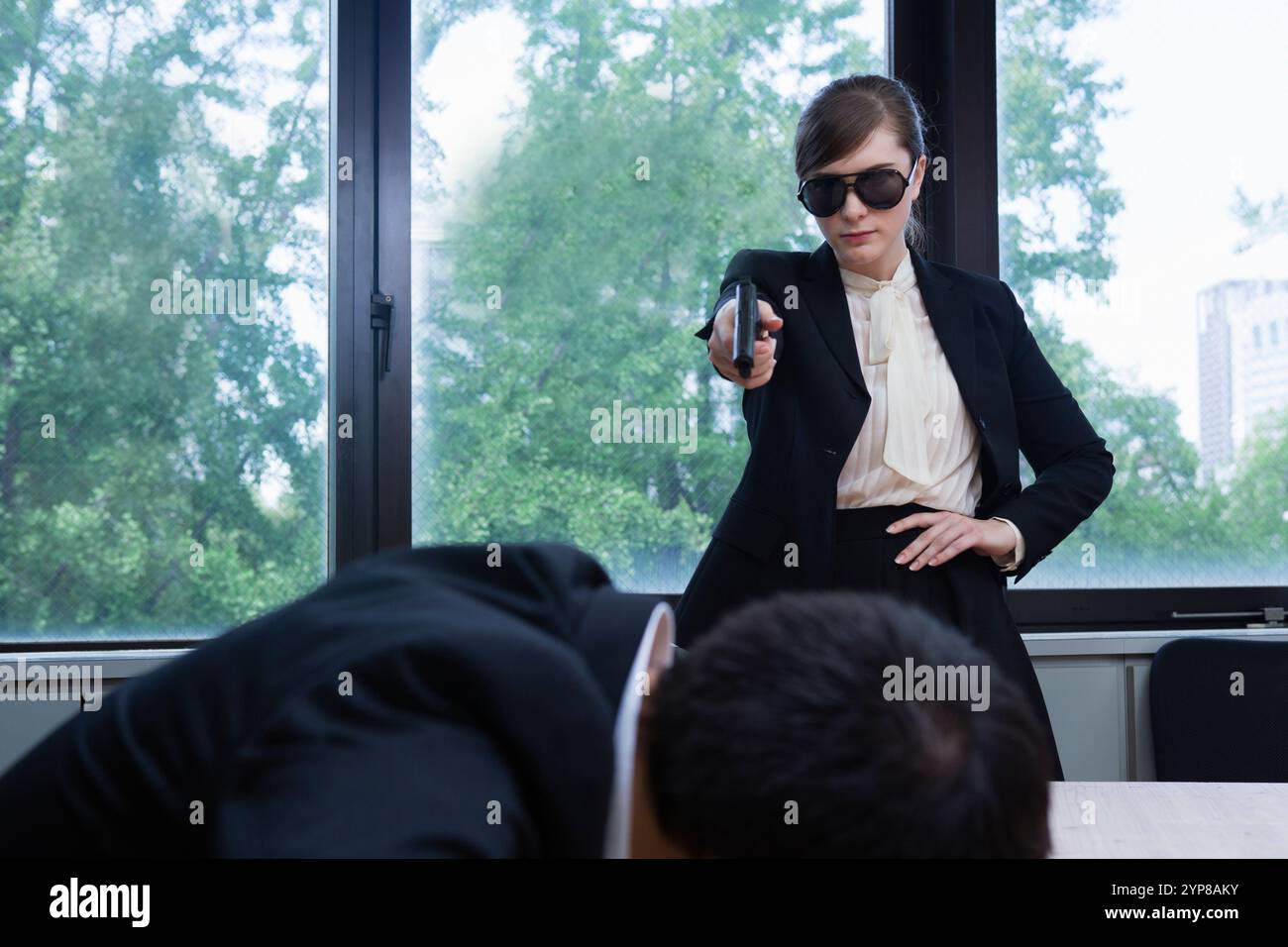 Female assassin in suit Stock Photo - Alamy