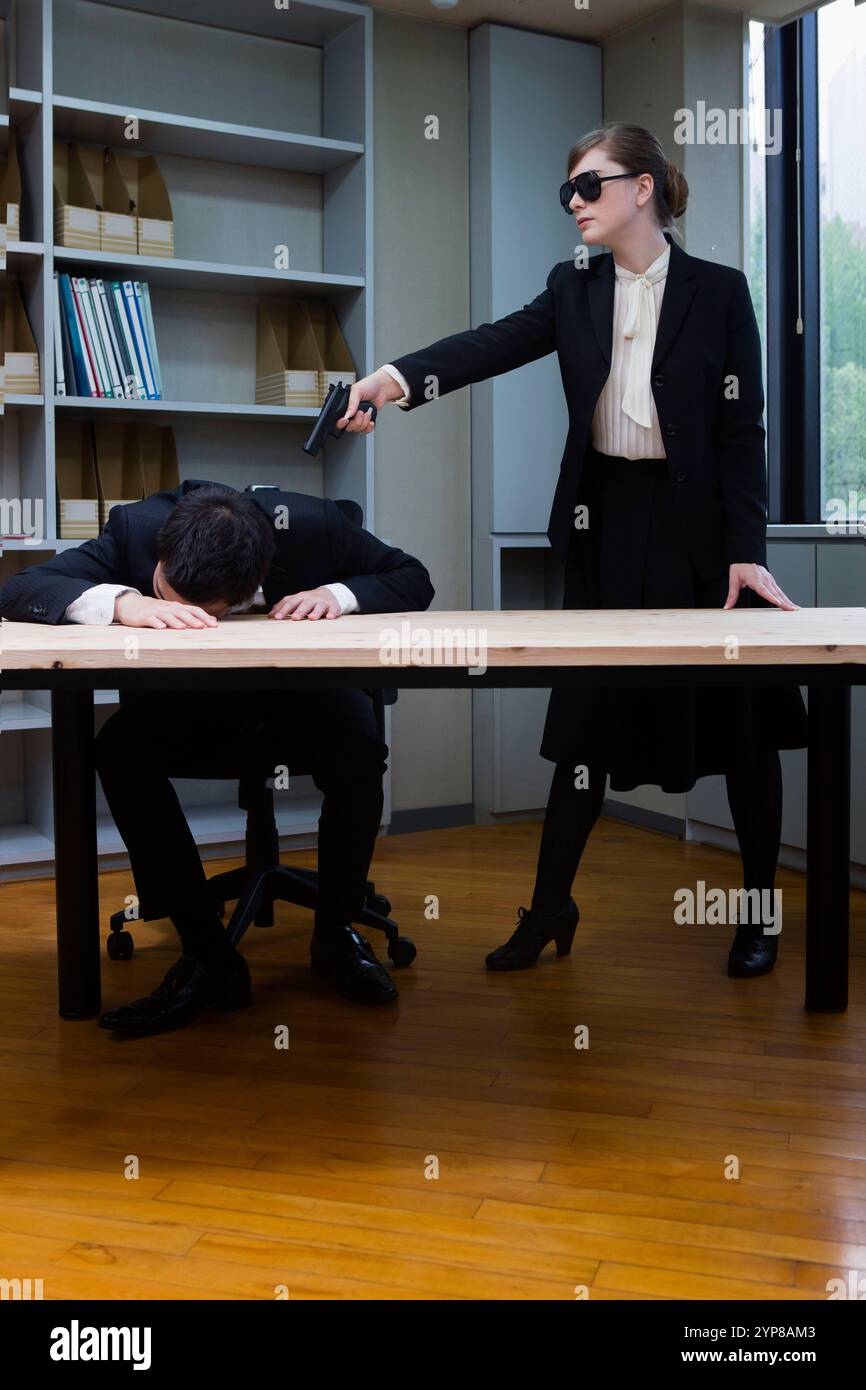 Female assassin in suit Stock Photo - Alamy