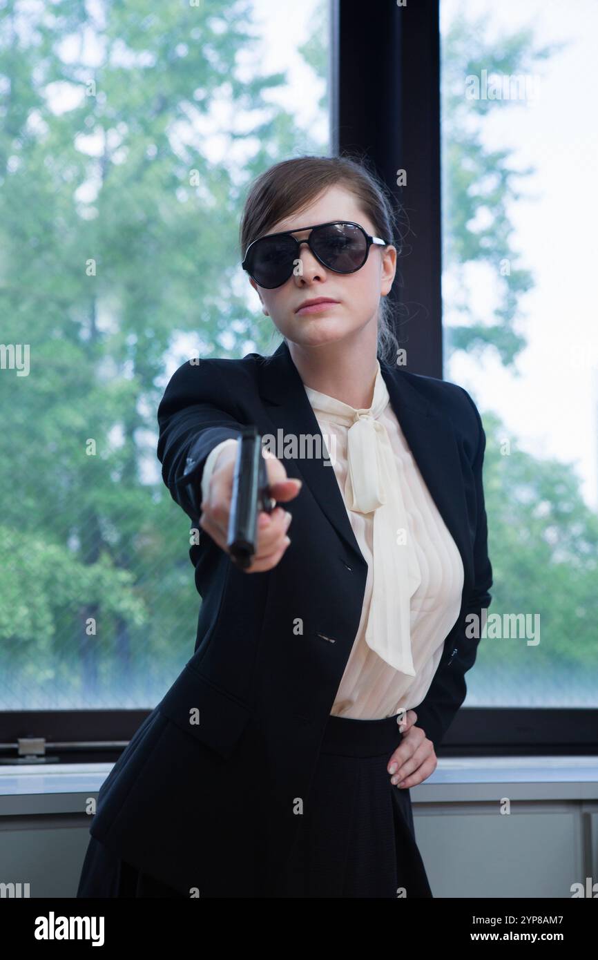 Female assassin in suit Stock Photo - Alamy